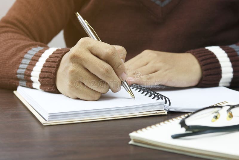 Hand of People, Student Writing and Note on Notebook on Wood Table with ...