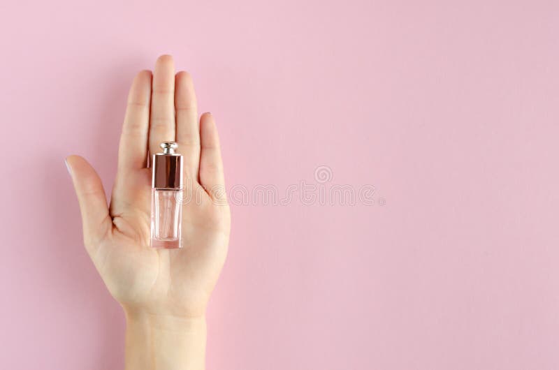 Hand with Perfume Bottle Composition on Blue Background Stock Photo ...