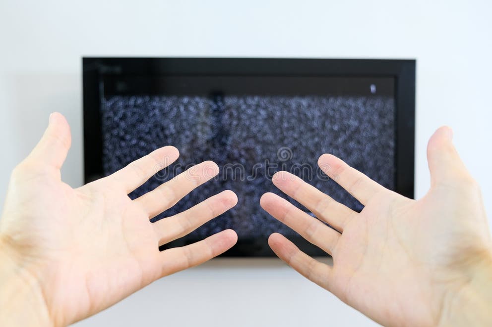 Hand of a Perplexed Person in Front of the Screen with White Noise on ...