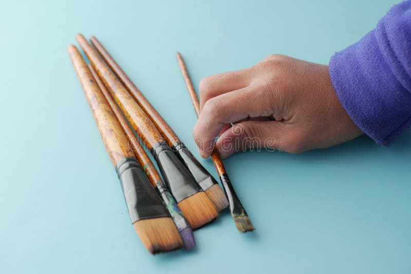 Hand Pick Art Brush on Table Close Up Stock Photo - Image of hand ...