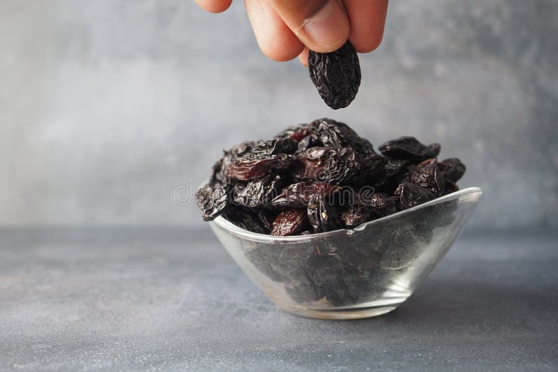 Hand Pick Black Raisin from a Bowl Stock Image - Image of food, dried ...
