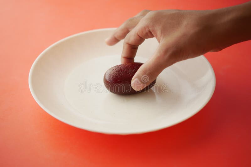 Hand pick a indian sweet stock image. Image of sugar - 265685707