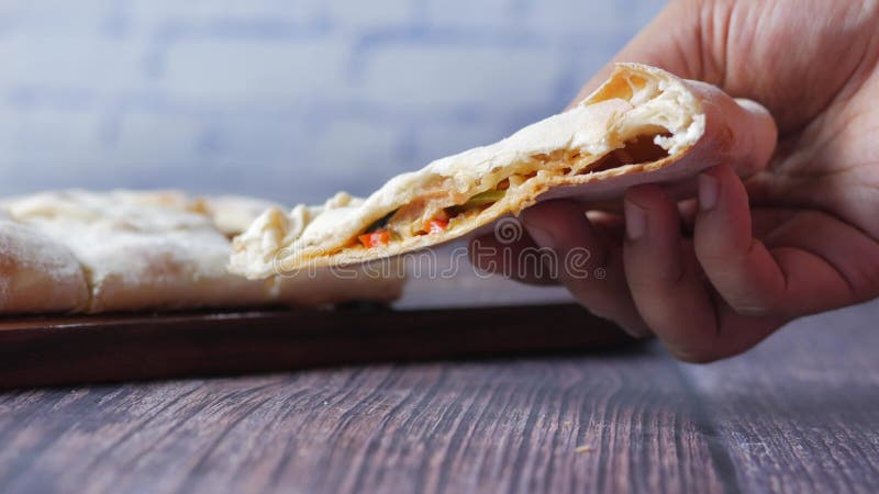 Hand Pick a Pizza Calzone on a Table Stock Video - Video of mozzarella ...