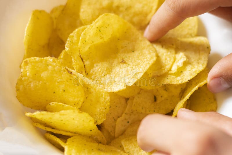 Hand Pick Take the Fried Potato Chips from the Plate F Stock Image ...