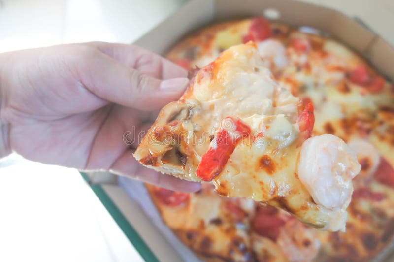 Hand picked pizza stock photo. Image of delivery, food - 87724440