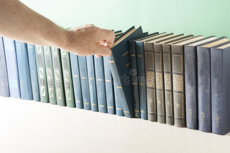 Hand Picking Book from the Shelf in Library Stock Image - Image of ...