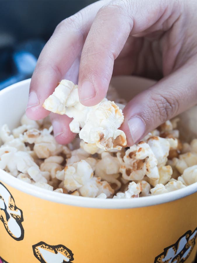 Hand picking popcorn stock image. Image of light, close - 49608531