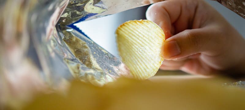 Hand Picking Potato Chips Inside Snack Bag Stock Photo - Image of hold ...