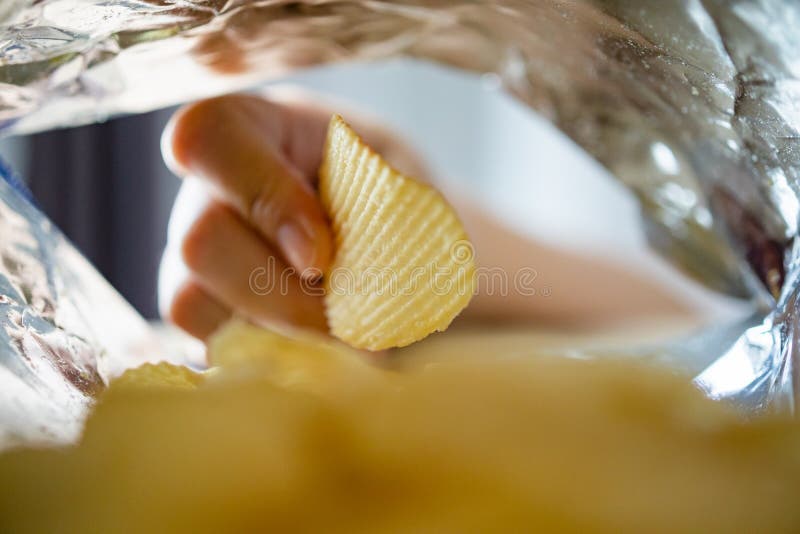 Hand Picking Potato Chips Inside Snack Bag Stock Photo - Image of ...