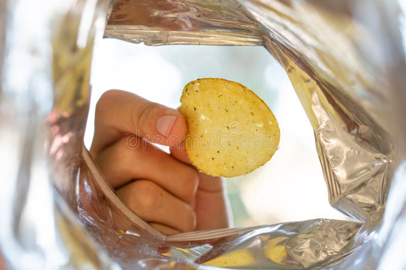 Hand Picking Potato Chips Inside Snack Bag. Open Pack of Chips. Inside ...