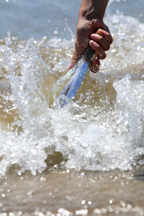 Hand Picking Up Glass Bottle with Message from Sea Stock Image - Image ...