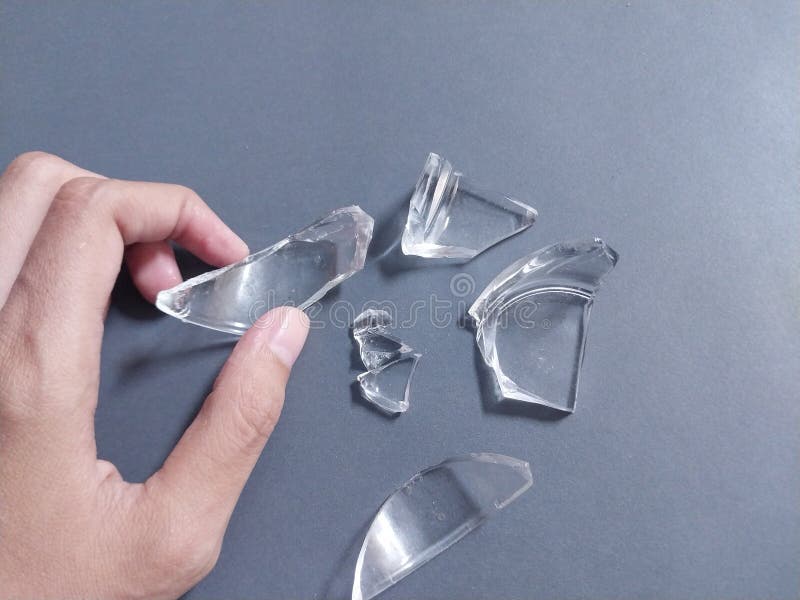 A Hand Picking Up a Piece of Broken Glass Stock Photo - Image of clean ...
