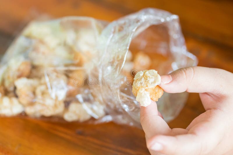 Hand Picking Up Pork Snacks in Bag on Table Stock Image - Image of ...