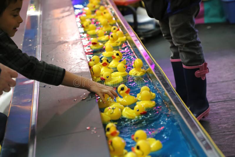 Hand picking yellow duck editorial photo. Image of cute - 52673516
