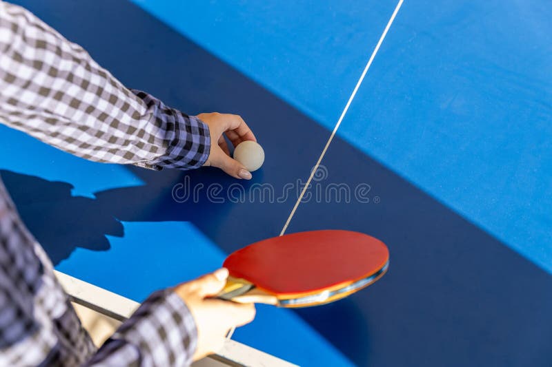 Hand with a Ping Pong Racket Hitting the Ball Above the Table Banner ...