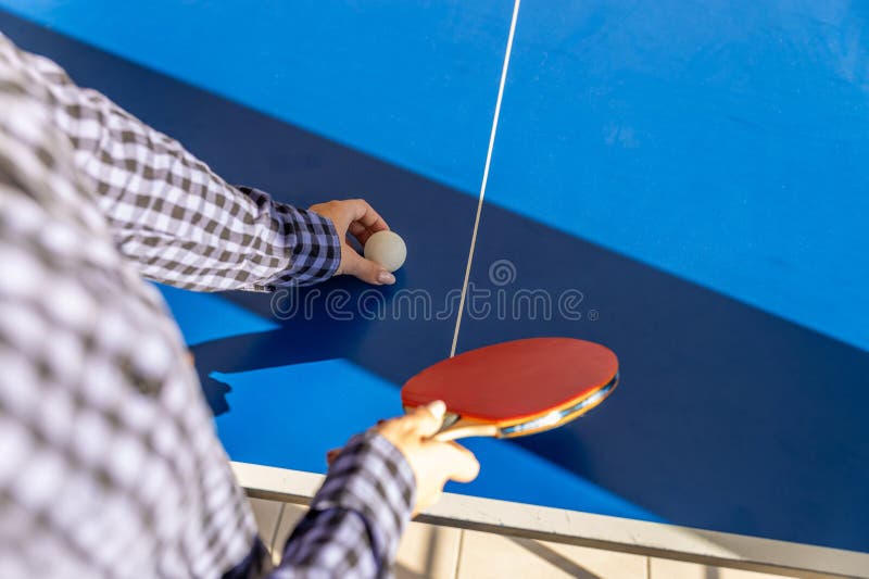 Hand with a Ping Pong Racket Hitting the Ball Above the Table Banner ...