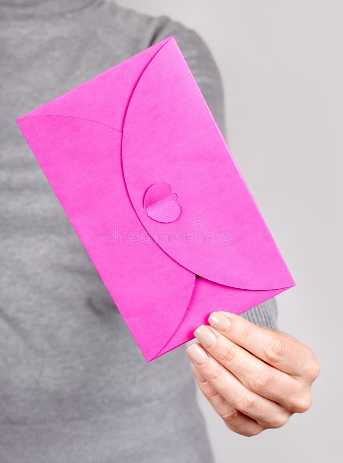 Hand with Pink Paper Envelope on Grey Background Stock Image - Image of ...