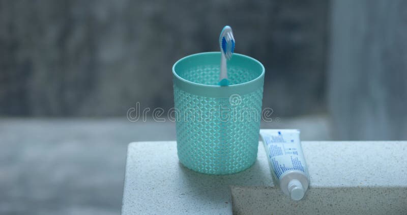 Hand Places Toothbrush Back in Cup Marking End of Dental Hygiene ...