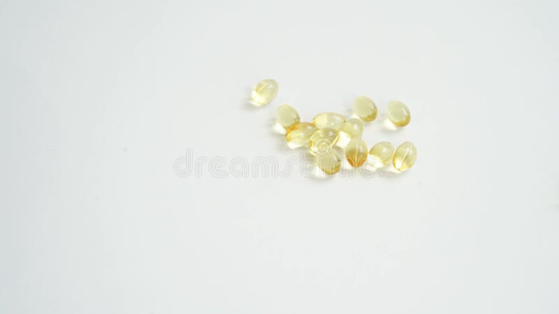Hand Placing Capsules on White Surface and Scattered Arrangement in ...