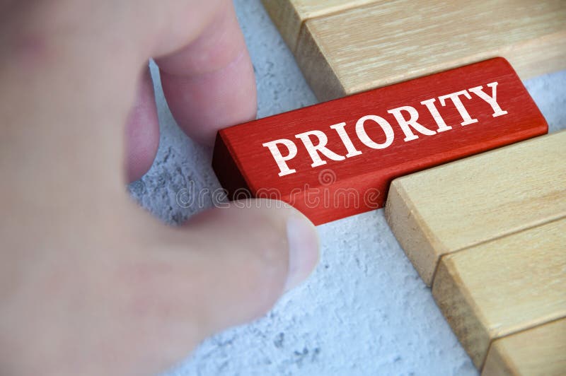 Hand Placing Red Wooden Blocks with Text - Priority. Priority and ...