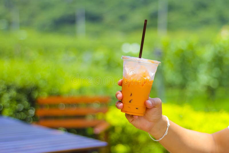 Hand with Plastic Glass of Iced Tea on Table. Stock Image - Image of ...