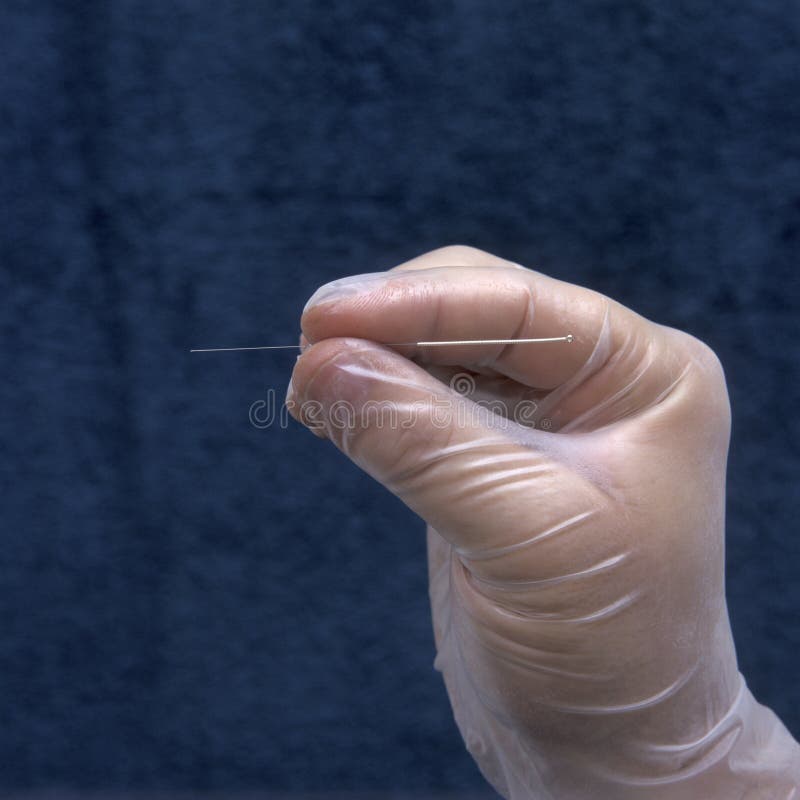 Hand with a Plastic Glove Holding an Acupuncture Needle Stock Photo ...