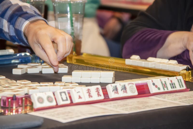 Hand of Player Reaching for Tile in a Game of Mahjong - Selective Focus ...