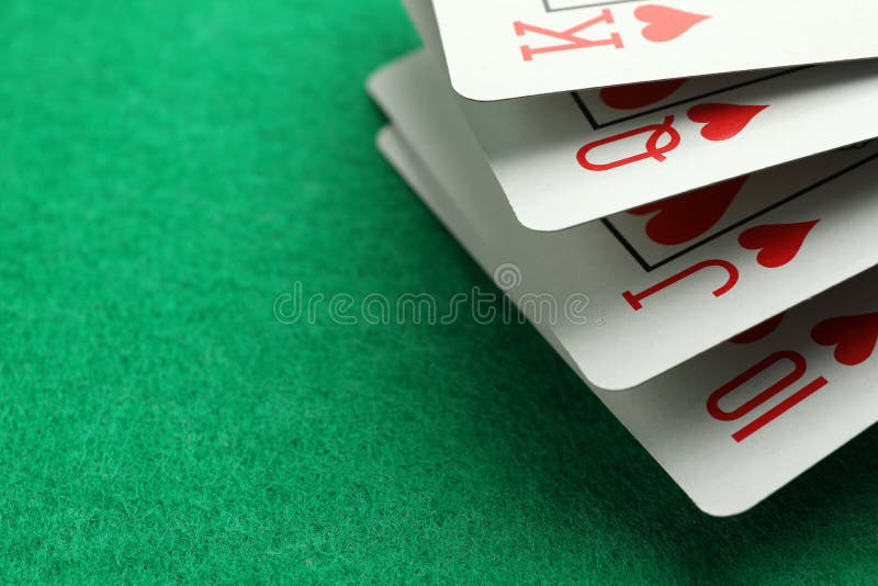 Hand of Playing Cards on Green Table, Closeup. Space for Text Stock ...