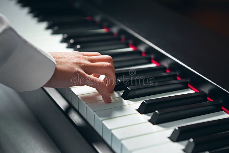 Hand playing the piano stock image. Image of instrument - 64444675