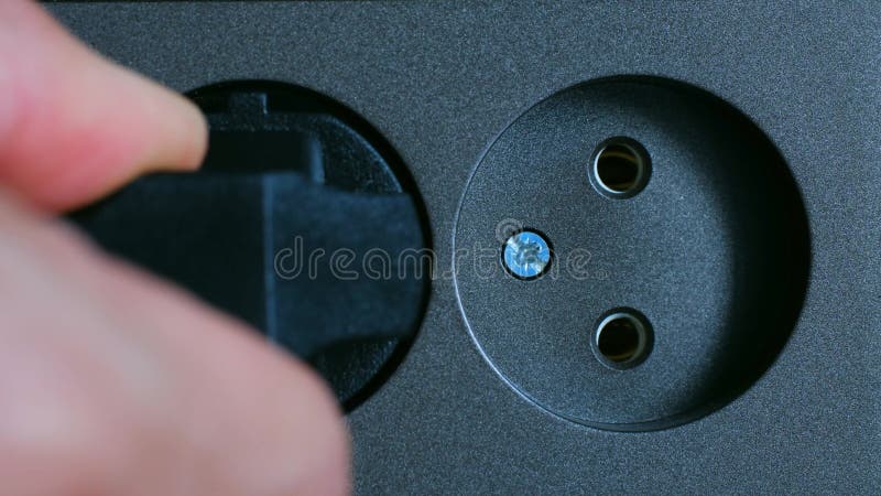 Electrician Plugging a Black Plug into a Grey Wall Socket Stock Video ...