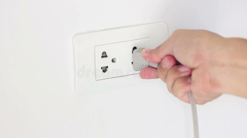 Unplugging an Electrical Power Cord from a Wall Socket in the Office ...