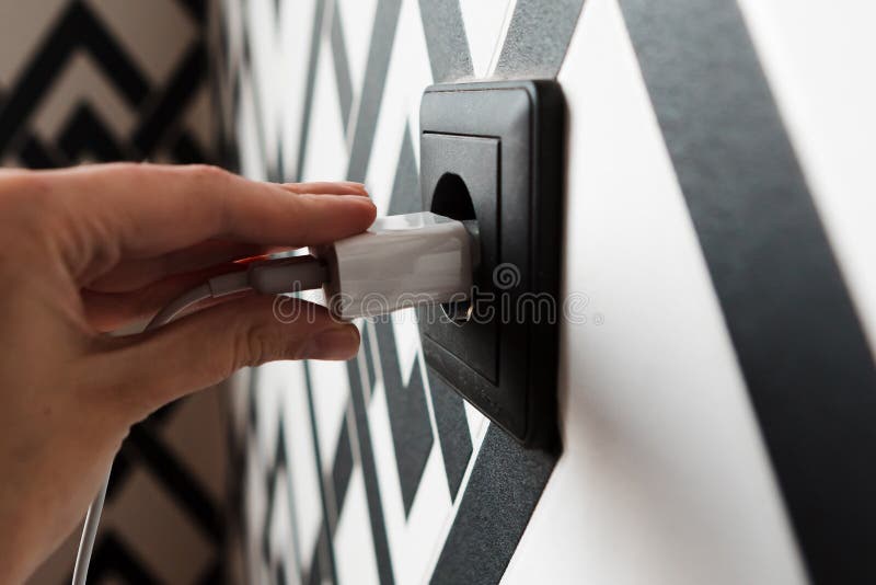 Hand Plugs into a Power Outlet Stock Photo - Image of technology ...