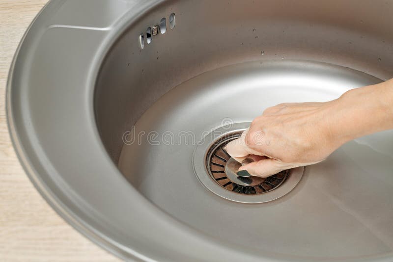 Hand Plugs the Sink Drain Hole with a Drain Plug. Stock Photo - Image ...