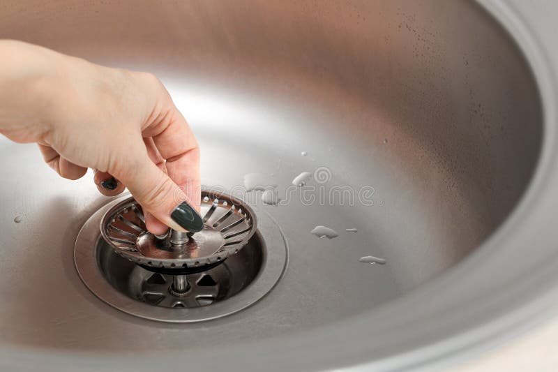 Hand Plugs the Sink Drain Hole with a Drain Plug. Stock Photo - Image ...