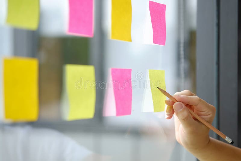 Hand Point Sticky Note Reminder on Glass Windows in Business Off Stock ...