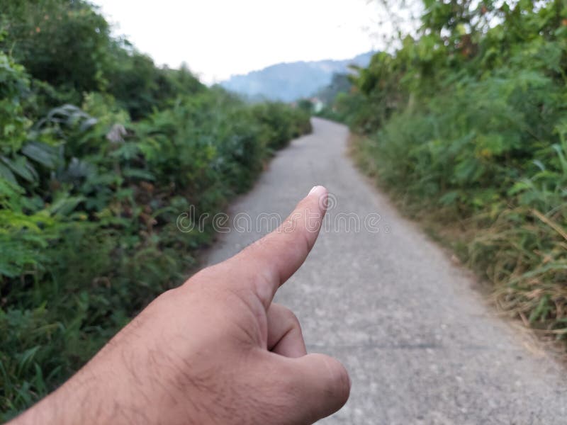 A Hand is Pointing a Direction Stock Photo - Image of grass, footwear ...