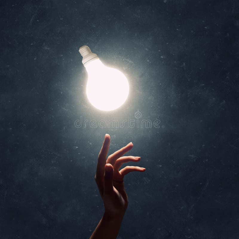 Hand pointing light bulb stock photo. Image of light - 70480170