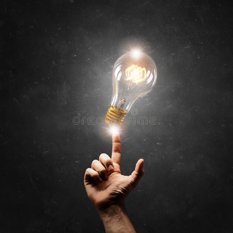 Hand pointing light bulb stock photo. Image of glass - 70589758