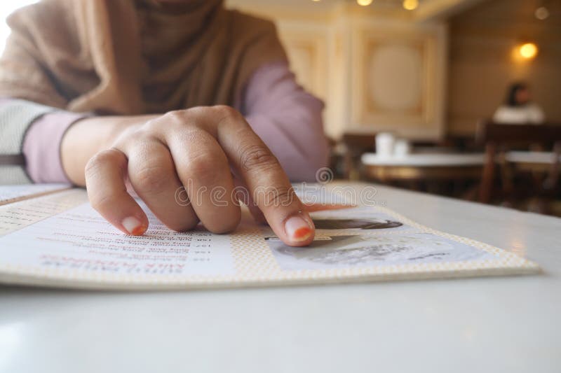 Hand Pointing at Menu in a Cozy Cafe during Afternoon Hours Stock Image ...