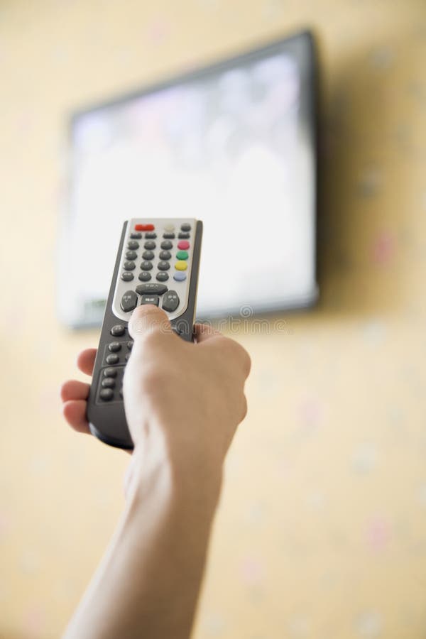 Hand Pointing Remote at TV stock image. Image of choice - 12564411