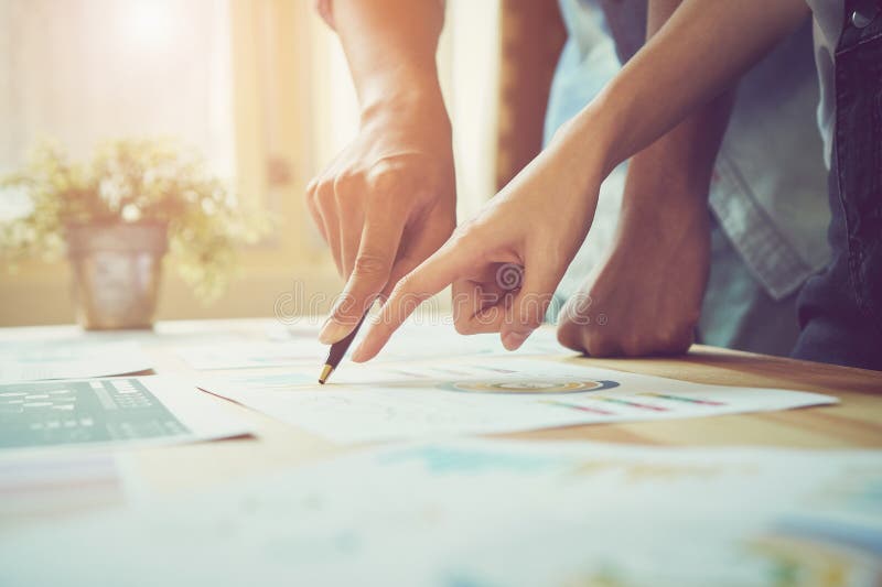 Hand Pointing To a Financial Document on the Desk. between the Agreed ...