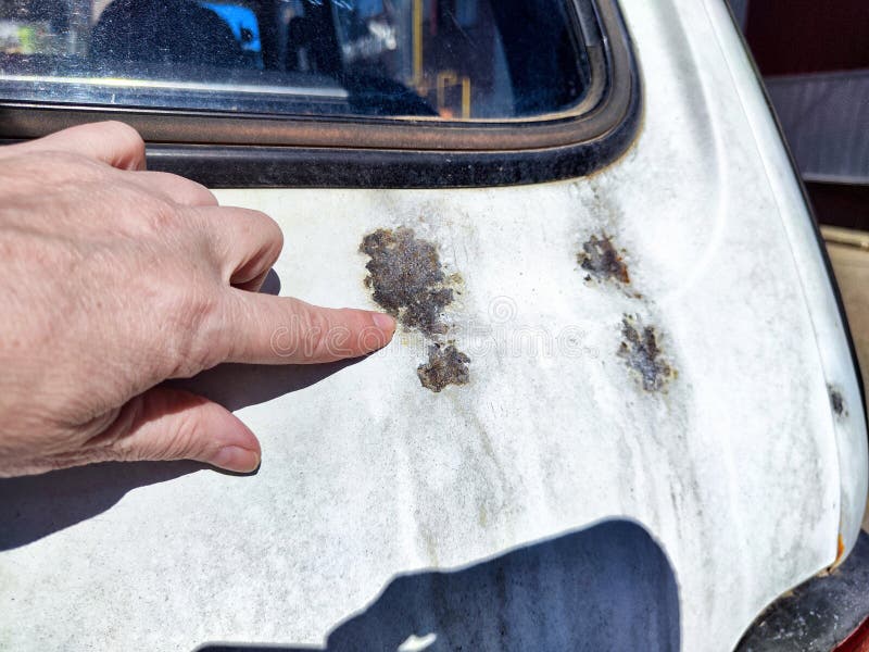 A Hand Points at Rust Damage on a Cars Body Panel Stock Image - Image ...
