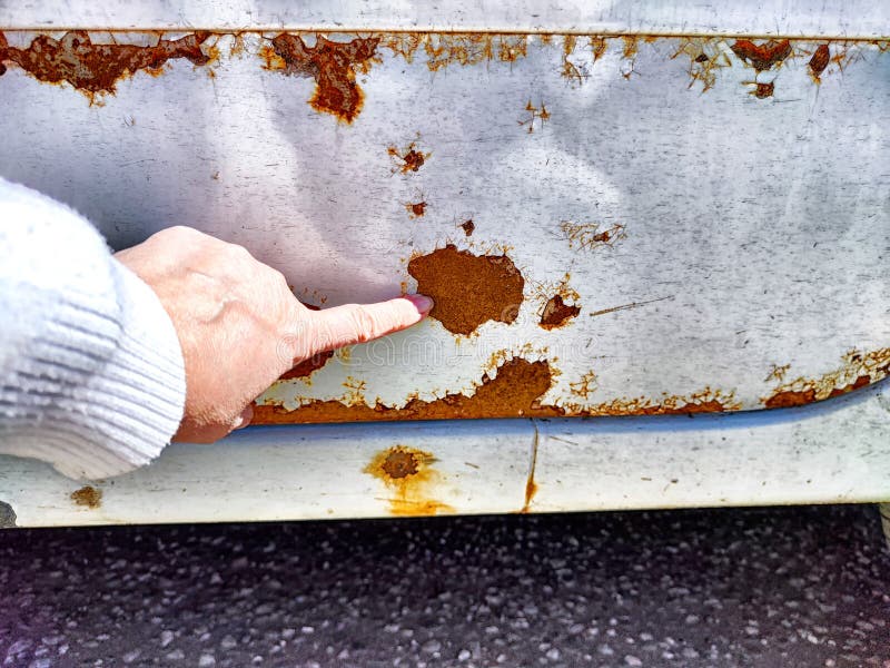 A Hand Points at Rust Damage on a Cars Body Panel Stock Photo - Image ...