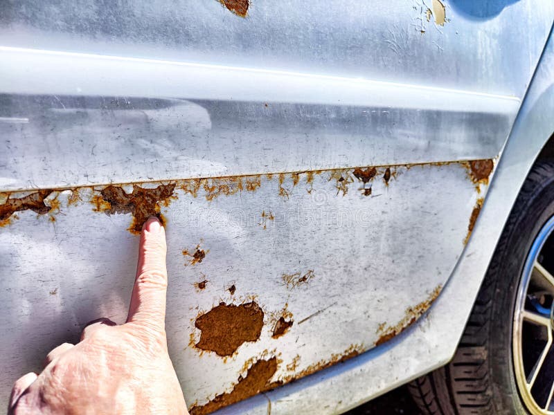 A Hand Points at Rust Damage on a Cars Body Panel Stock Image - Image ...