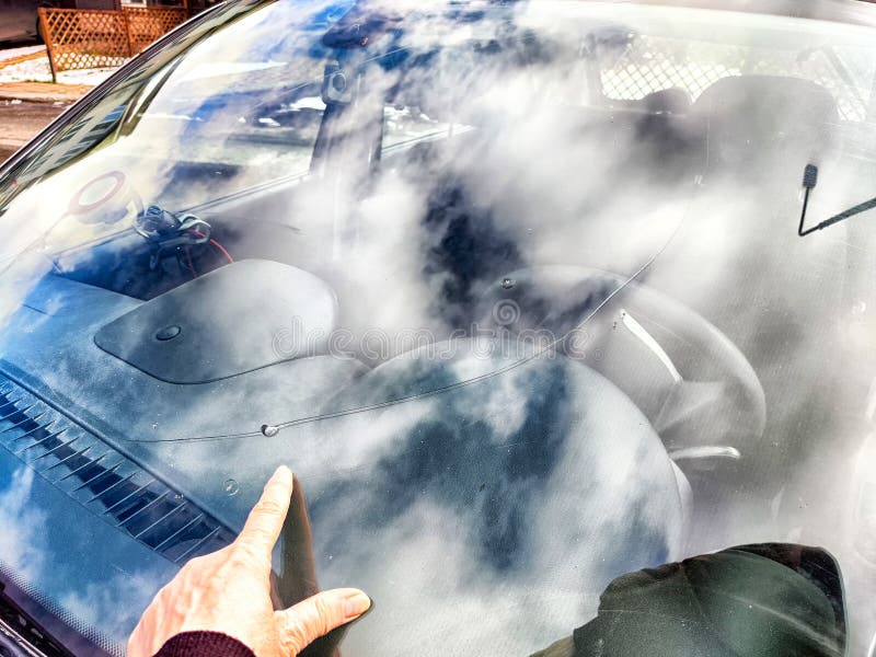 A Hand Points at a Small Chip and Crack on a Car Windshield Stock Image ...