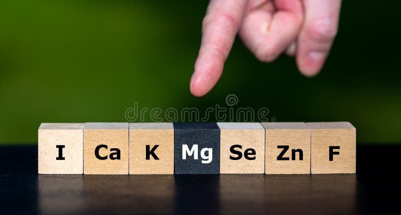 Hand Points To a Cube with the Letter Mg Stock Photo - Image of heart ...