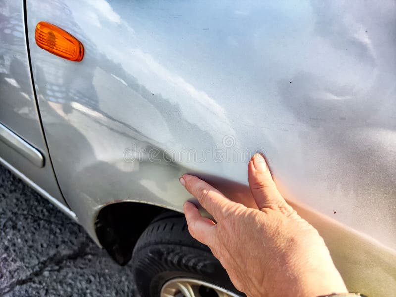 A Hand Points To a Dent on a Silver Car Door Stock Image - Image of ...
