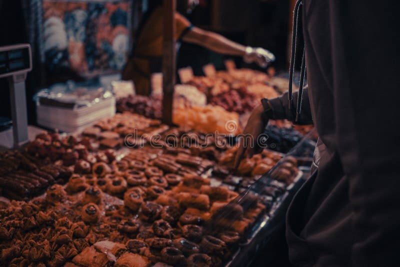 The Hand Points To the Goods in the Market Counter with Oriental Sweets ...