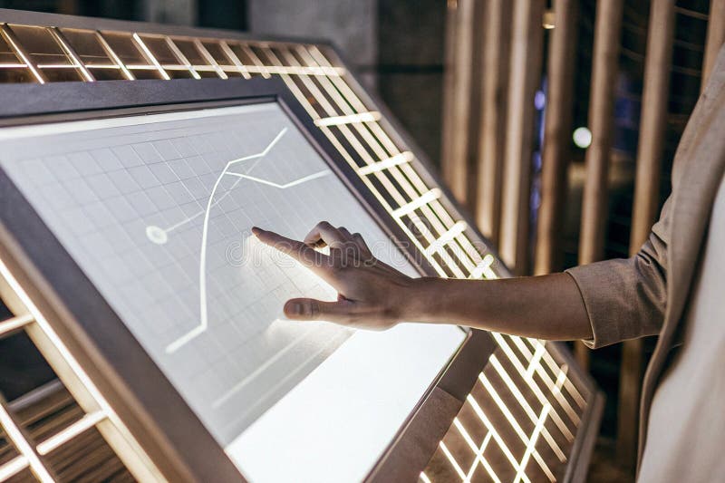 A Hand Points To an Interactive Digital Display Showing a Glowing Line ...