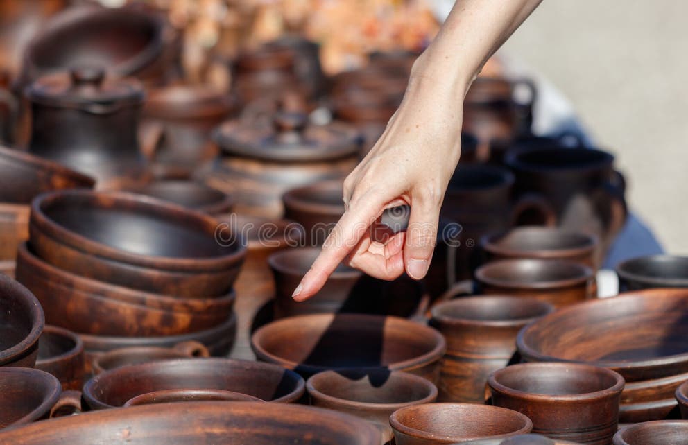 A Hand Points To a Pot on a Table Stock Photo - Image of work, natural ...